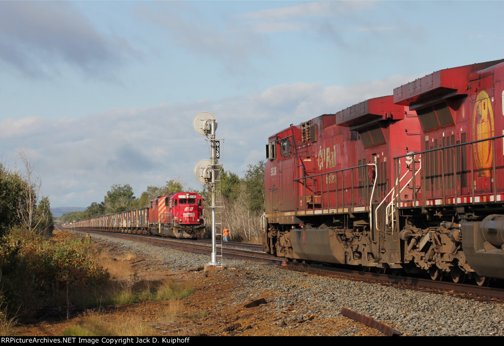 CP 9736 roars past SOO 6049 at the east siding switch,